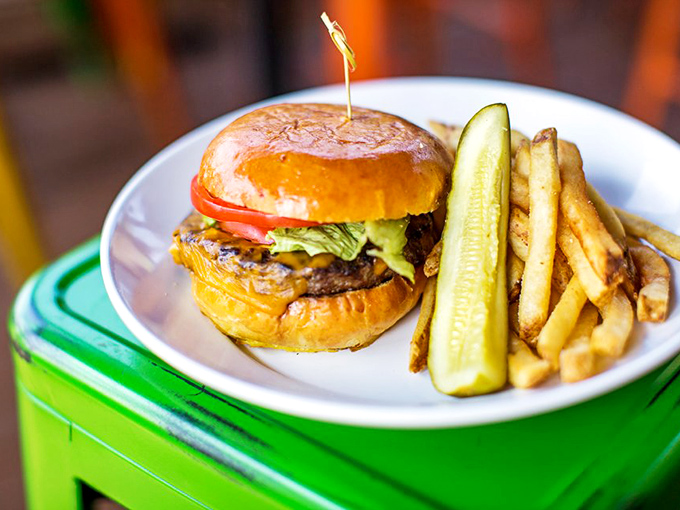 This isn't just a burger &ndash; it's edible architecture with a PhD in satisfaction, complete with that perfectly toasted bun and a pickle standing guard.