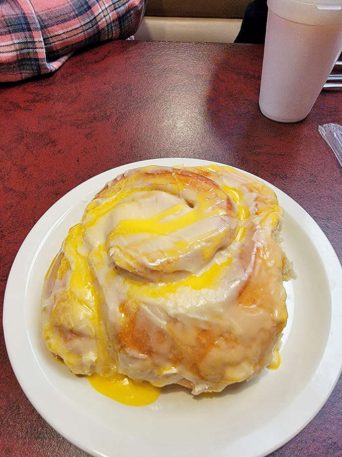 Behold the crown jewel: a cinnamon roll so decadent it should require a permission slip. That butter-yellow drizzle isn't asking for attention&mdash;it's demanding it.