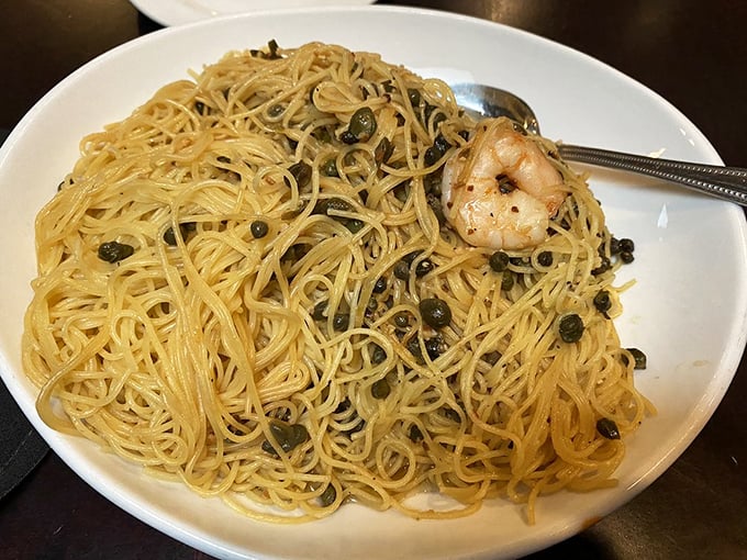 Capellini Scampi that makes you want to high-five the chef. Delicate angel hair pasta tangled with plump shrimp and those magical little capers.