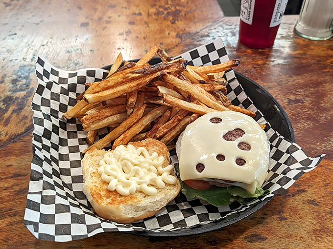 This isn't just a cheeseburger&mdash;it's edible architecture. Hand-cut fries and mac-topped burger create a carb symphony that makes nutritionists weep and taste buds rejoice.