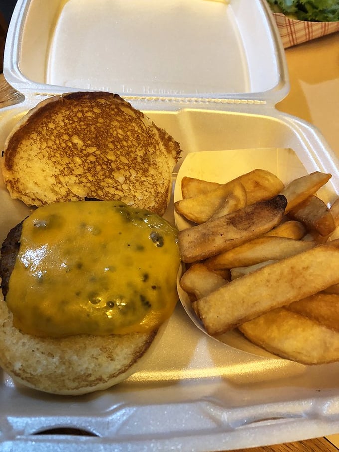 Behold the burger in its natural habitat&mdash;surrounded by golden onion rings and dressed to impress with fresh veggies and melty cheese. 
