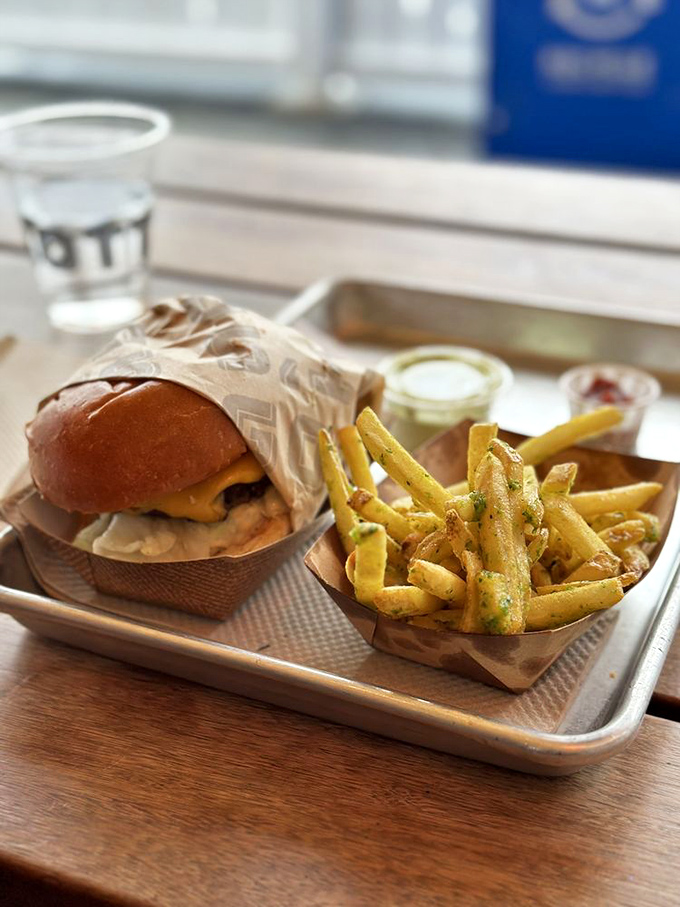 This isn't just a cheeseburger and fries&mdash;it's edible architecture where each golden garlic fry stands at attention beside its beefy companion.