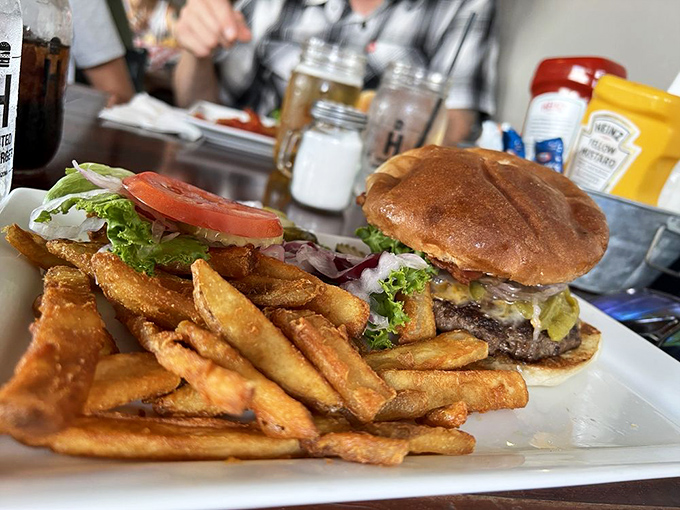 This isn't just a cheeseburger—it's architecture. The golden fries aren't sidekicks; they're co-stars in this delicious drama.