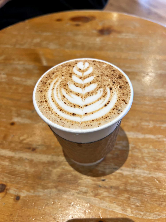 Latte art so pretty you almost don't want to drink it. Almost. That leaf design is practically begging for its Instagram moment.