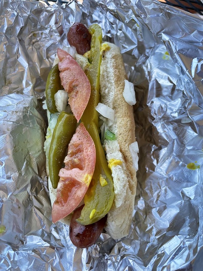 This isn't just a Chicago dog; it's an architectural masterpiece where pickle spears, tomato and peppers create the skyline of flavor city.