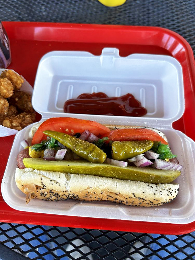 The Chicago-style hot dog arrives like an edible work of art&mdash;pickle spears standing at attention while sport peppers add that perfect Windy City kick.