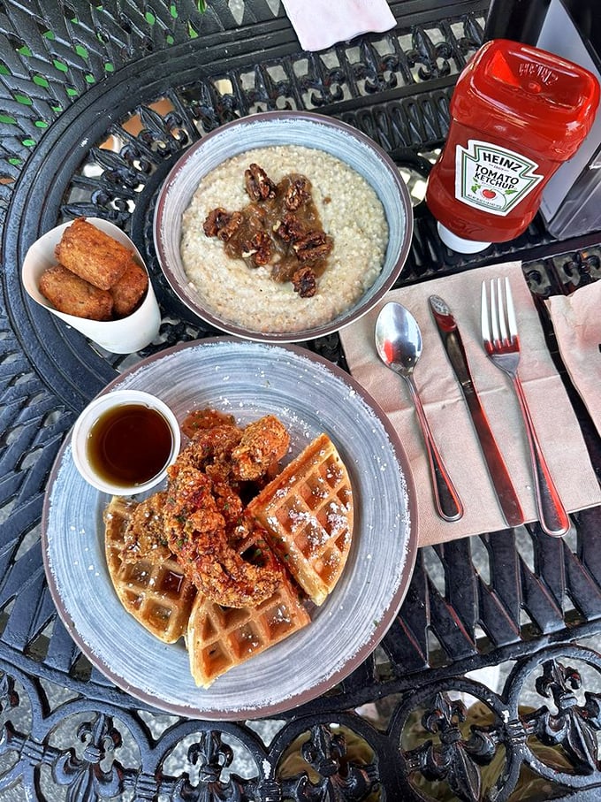 Comfort food nirvana: golden waffles paired with grits that would make any Southern grandmother nod in approval. That bottle of ketchup stands ready for the breakfast purists.