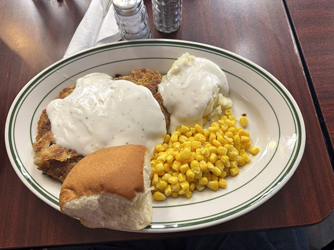 Country-fried steak smothered in pepper-flecked gravy, alongside buttery corn and a fresh roll&mdash;this plate doesn't just feed your body, it hugs your soul.