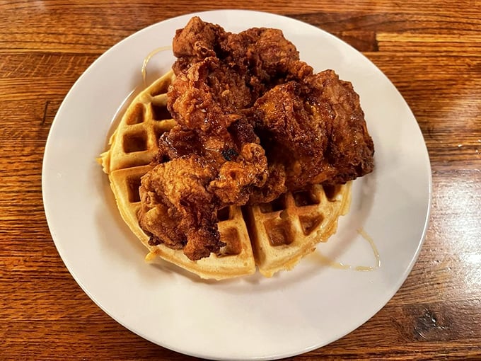 The chicken and waffle plate arrives like breakfast royalty&mdash;golden, crispy coating giving way to juicy meat, all lounging on a waffle throne.
