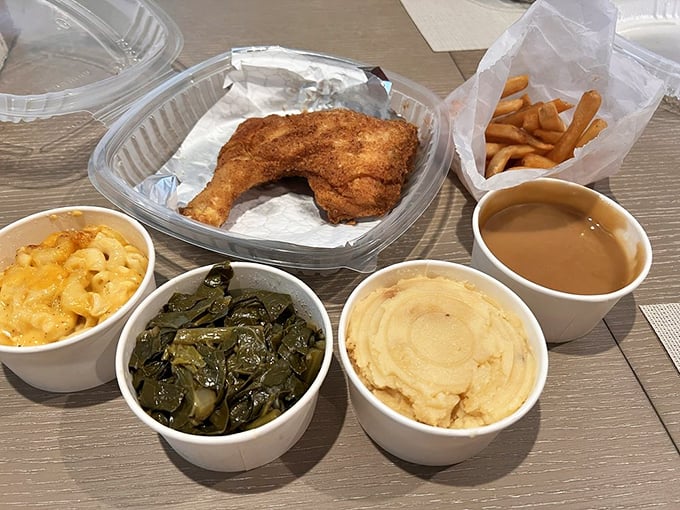 That golden-brown chicken leg sits proudly next to cloud-like mashed potatoes and greens that would make any grandmother nod in approval.
