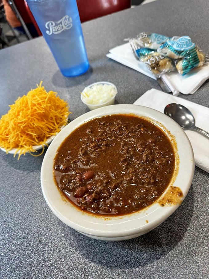 Cincinnati chili in its natural habitat &ndash; a bowl of spiced goodness with kidney beans, ready for a sprinkle of oyster crackers