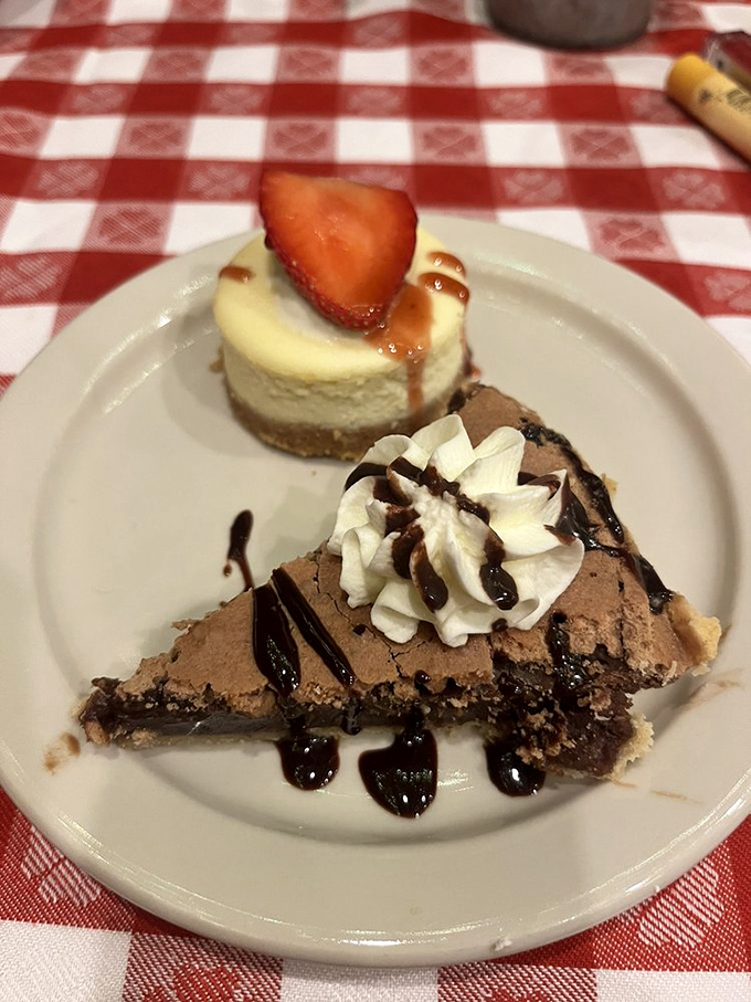 A slice of heaven on a plate&mdash;the legendary chocolate chess pie topped with whipped cream and strawberry cheesecake, displayed on classic diner tableware.
