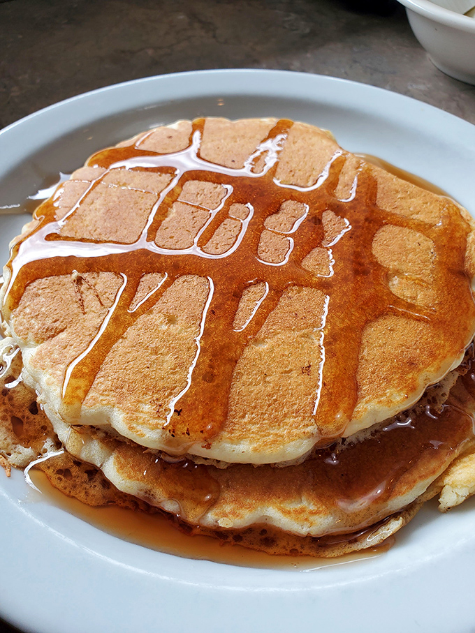 Golden-brown pancake perfection! These fluffy discs of joy, glistening with maple syrup, are what breakfast dreams are made of.