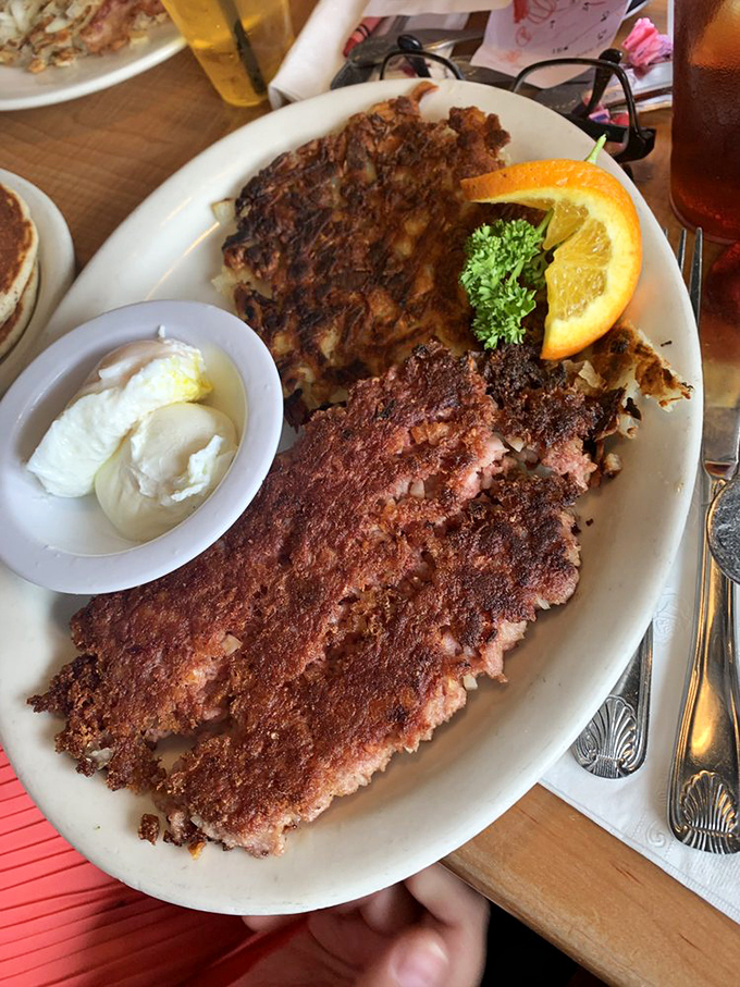 Behold the star attraction: corned beef hash with a crackling crust that yields to tender, savory meat within &ndash; breakfast alchemy at its finest.