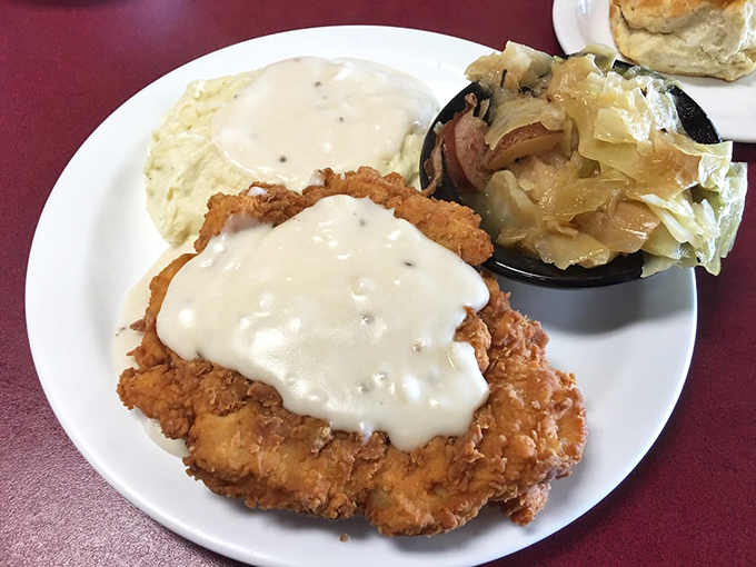 This country fried chicken doesn't just wear its golden crust like armor&mdash;it flaunts it. The gravy blanket and cabbage sidekick complete this comfort food trifecta.