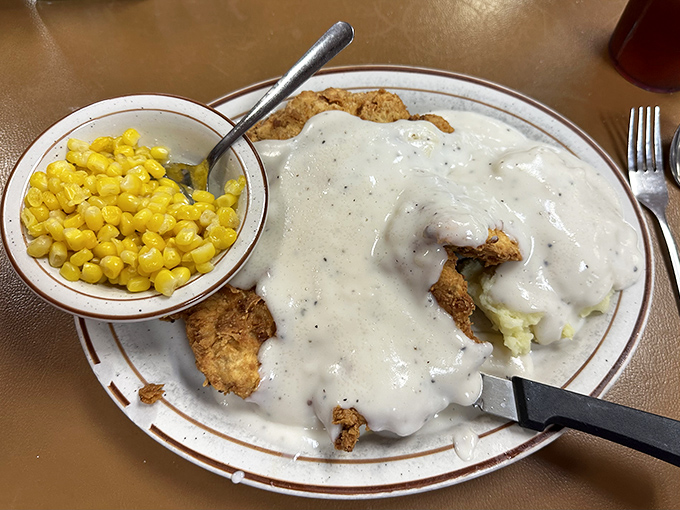 Behold the crown jewel: chicken fried steak swimming in pepper-flecked country gravy with a side of sweet corn. This plate has launched a thousand food pilgrimages.