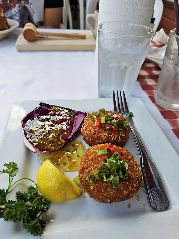 Golden-brown crab cakes that could make a Marylander question their loyalty, served with a splash of sauce that whispers, "You made the right choice."