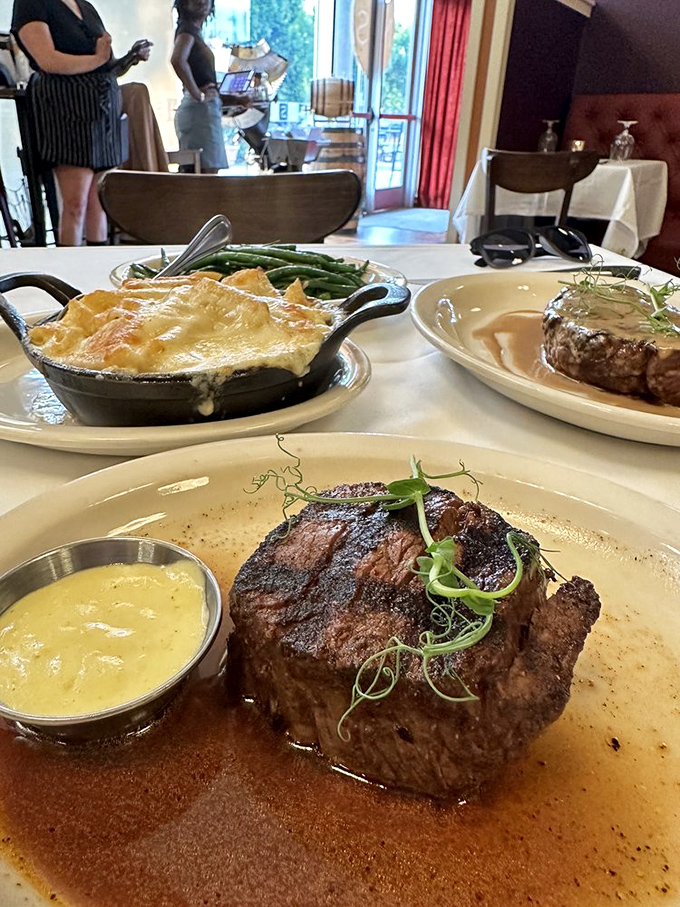 The filet mignon arrives with a side of mac and cheese that could make your grandmother question her life choices.