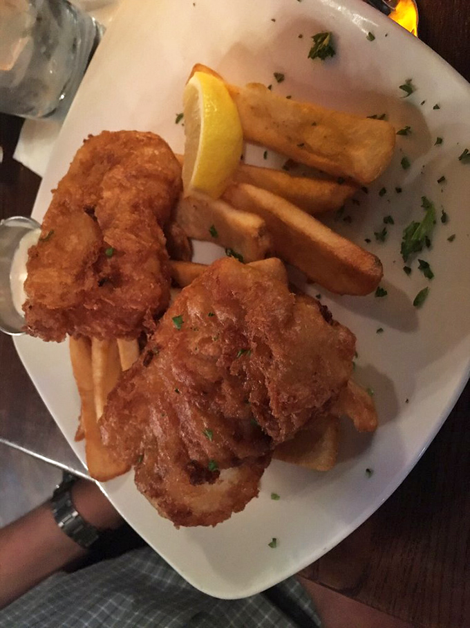 Golden-battered fish that shatters with each bite, revealing pearly white cod beneath. This isn't just dinner&mdash;it's edible architecture with a side of happiness. 