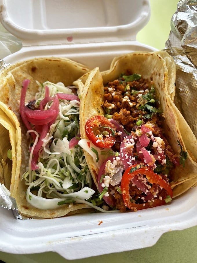 Two tacos walk into a takeout container and steal your heart. The one with pickled onions is particularly smug about it.