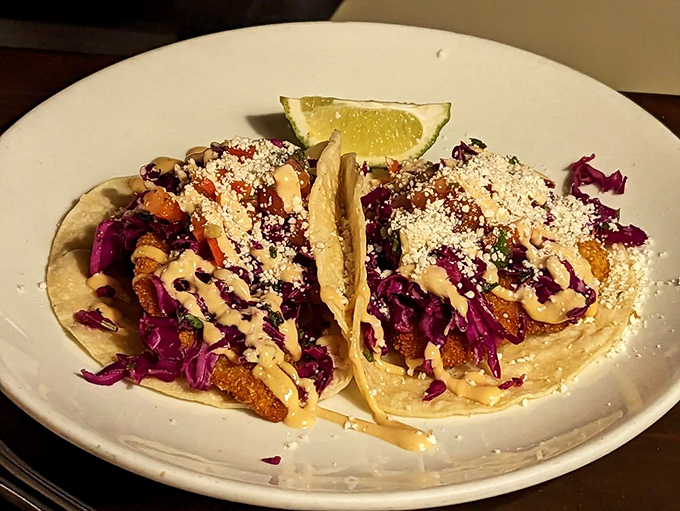 These fish tacos aren't just a meal&mdash;they're edible artwork where vibrant purple cabbage and creamy sauce frame perfectly crispy cod like a delicious Picasso. 