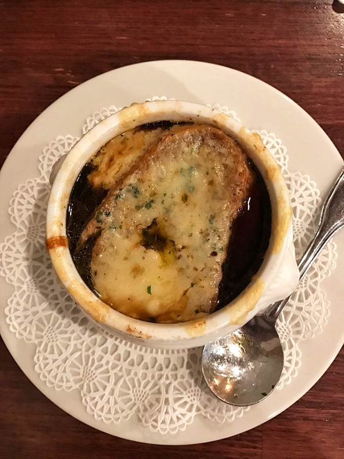 The French onion soup arrives like a work of art&mdash;that golden, bubbling cheese cap is begging to be broken into.