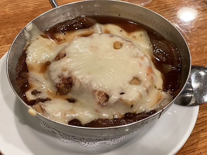 Behold, the crown jewel: French onion soup that makes you question all other soups you've ever known. That cheese pull deserves its own Instagram account.