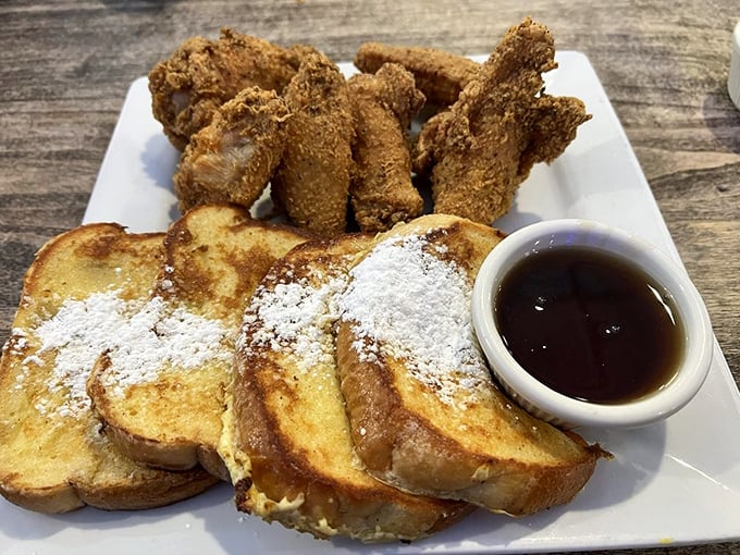 The ultimate breakfast power couple: golden French toast dusted with powdered sugar alongside crispy chicken wings. Who says you can't have it all?
