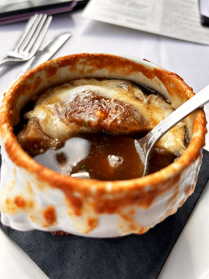 Behold the crown jewel: French onion soup with a cheese cap so perfect it deserves its own Instagram account.
