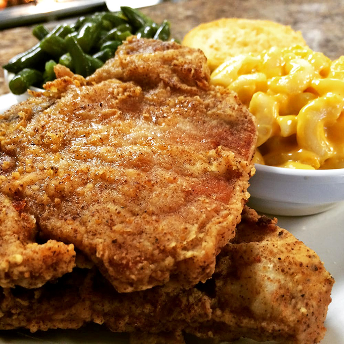 Golden-brown fried chicken that shatters with each bite, paired with creamy mac and cheese and vibrant green beans—a holy trinity of comfort.