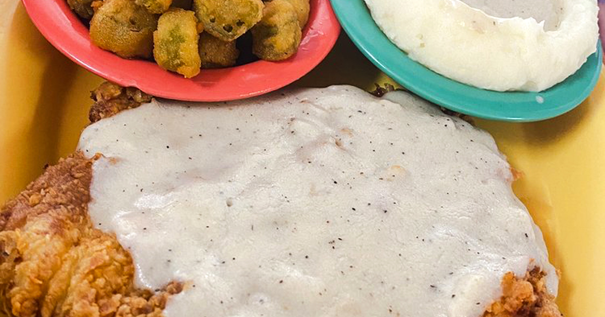 Behold the star of the show: golden-fried chicken under a blanket of peppery gravy, with sides that refuse to be mere supporting actors.