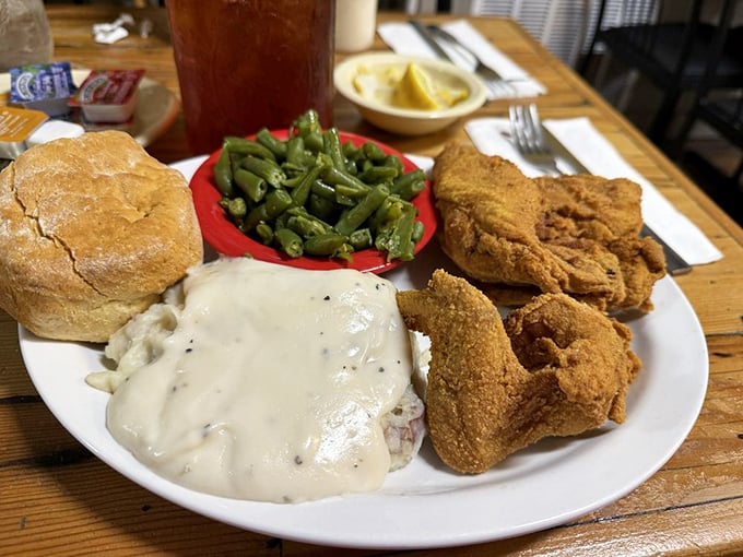 Golden-brown chicken that makes a satisfying crunch heard three tables over, nestled beside creamy potatoes that comfort like a childhood memory.