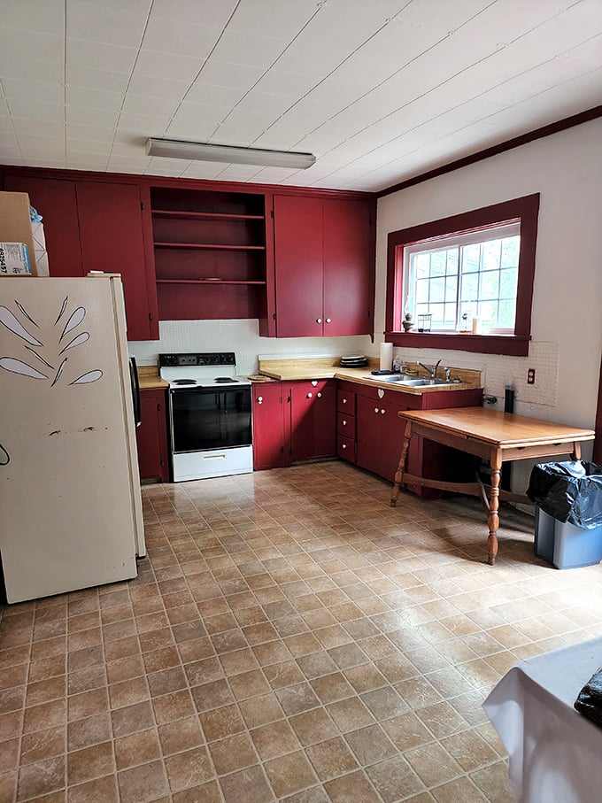 The kitchen's bold red cabinets add an unexpected pop of color. Wonder if the spirits prefer home cooking or takeout?