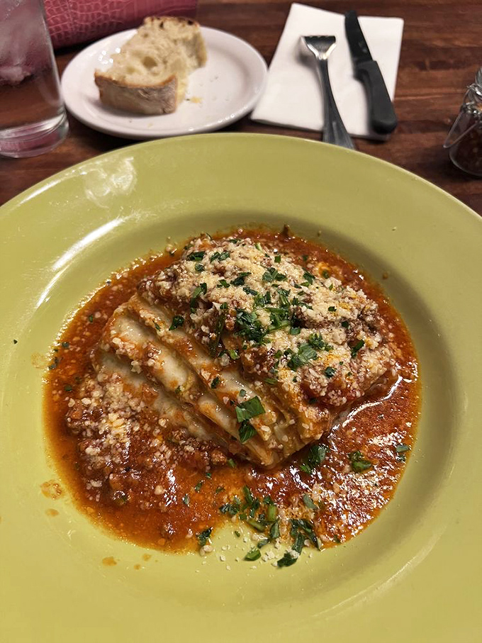 Behold the legendary lasagna in all its glory—layers of heaven swimming in a sauce so rich it probably has its own investment portfolio.