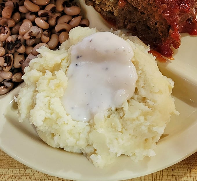 Cloud-like mashed potatoes crowned with pepper-flecked gravy&mdash;proof that heaven exists and it's made of starch and butter.