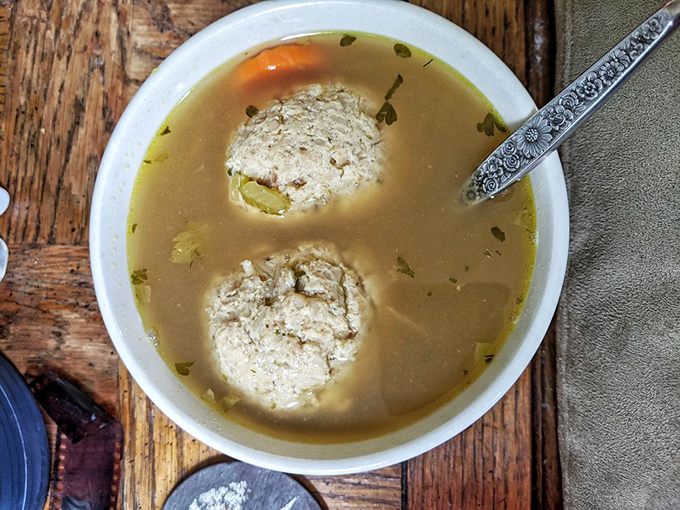 Behold the matzo ball soup in all its glory&mdash;two perfectly fluffy dumplings swimming in golden broth that's clearly been simmering since before your morning alarm went off.