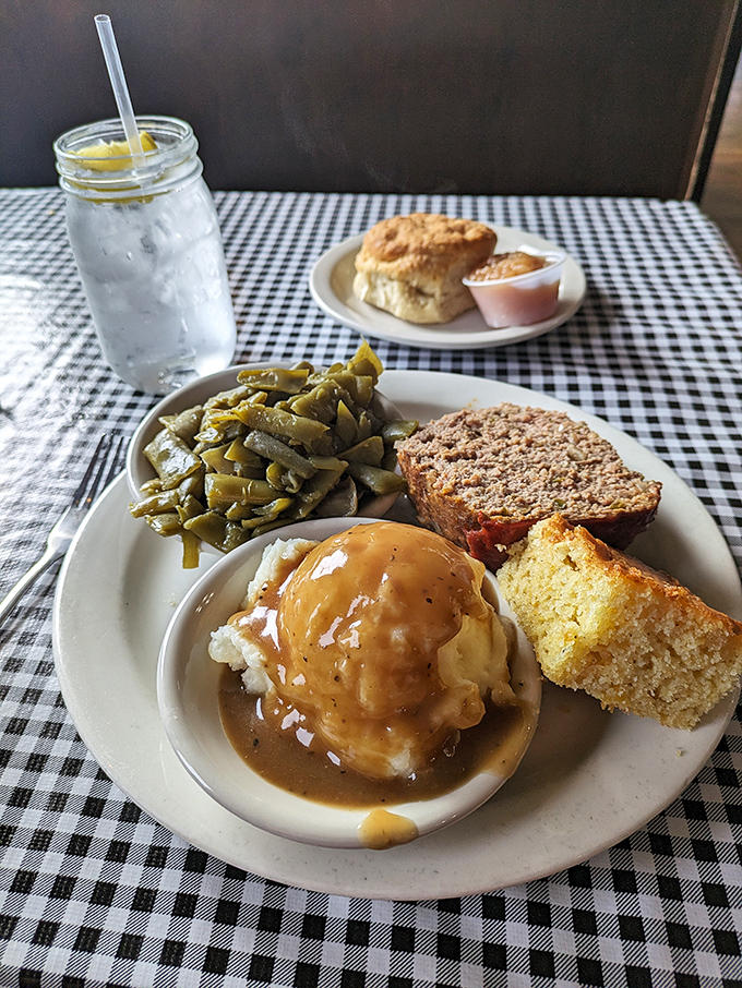 Southern trinity on full display: farm-fresh green beans, cloud-like mashed potatoes drowning in gravy, and meatloaf that'll make you call your mother.