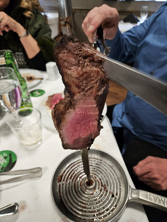 That moment when the gaucho arrives with a skewer taller than some NBA point guards. Your plate waits empty, but not for long
