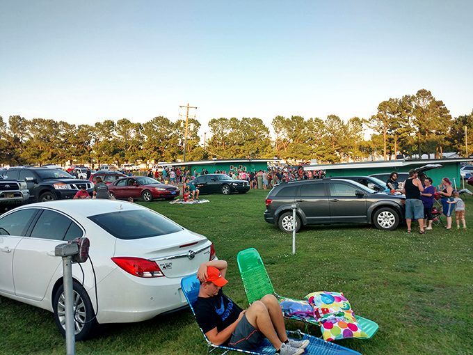 Families claim their spots before showtime, turning vehicles into cozy living rooms under the open sky.