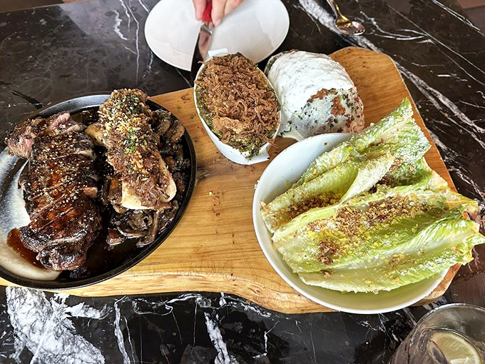 This carnivore's dream board features a perfectly seared steak alongside companions that aren't merely sidekicks but co-stars in this meaty production.