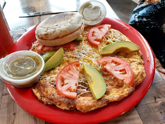 This isn't just an omelet&mdash;it's a cheese-draped masterpiece topped with fresh avocado and tomato. Breakfast artistry that makes waking up worthwhile.