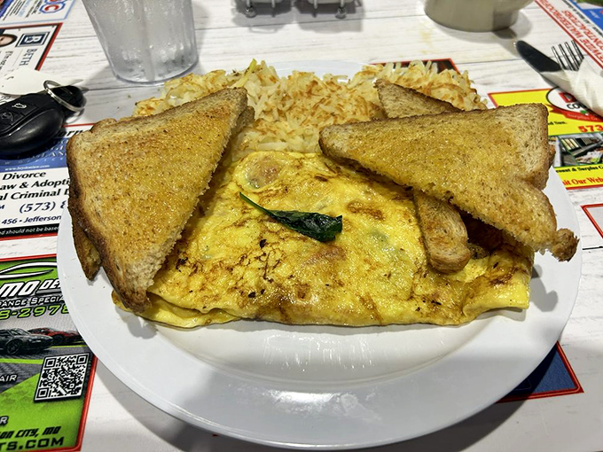 This isn't just any omelet; it's a golden-hued masterpiece with toast companions waiting for their moment of glory.