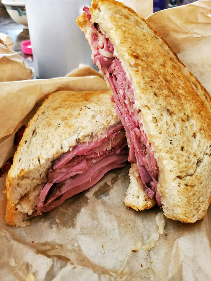 Pastrami piled high between perfectly grilled rye—this isn't just a sandwich, it's architecture with flavor. The structural integrity alone deserves applause.