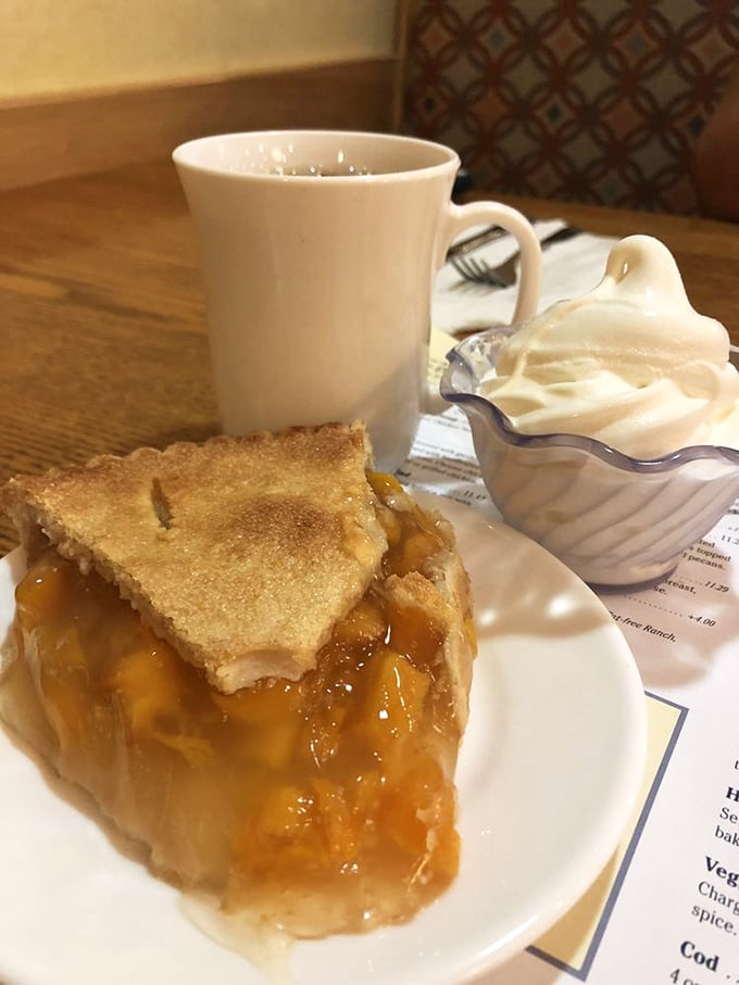 Peach pie that makes time stand still. Golden filling peeks through a perfectly flaky crust, while whipped cream waits patiently for its moment.