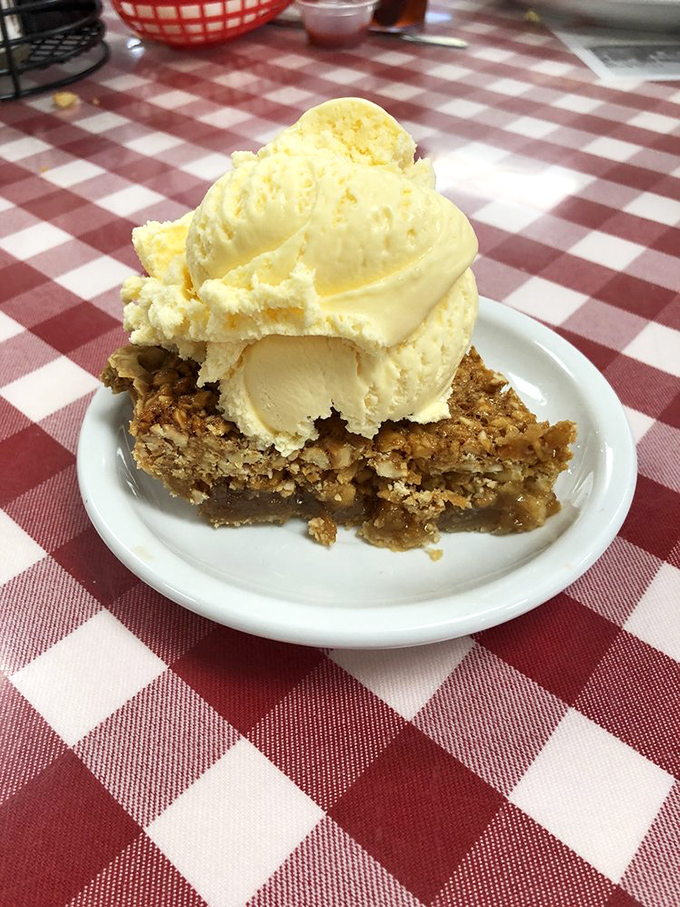 Heaven on a plate: warm peanut pie meets cold vanilla ice cream in a symphony of textures that'll make you close your eyes in bliss.