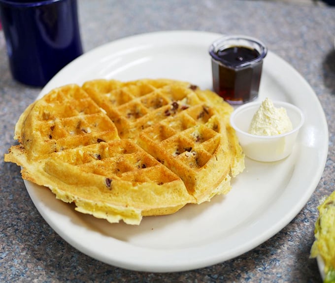 This pecan-studded Belgian waffle isn't just breakfast, it's architecture &ndash; golden peaks and valleys creating the perfect landscape for that melting butter island.