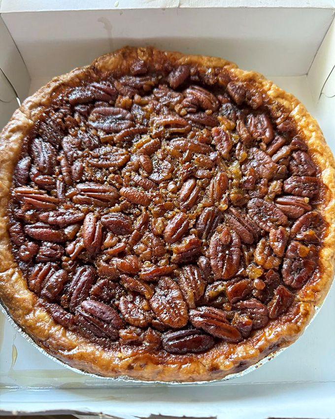 A pecan pie so perfectly arranged it looks like each pecan personally volunteered for the honor of being part of this masterpiece.