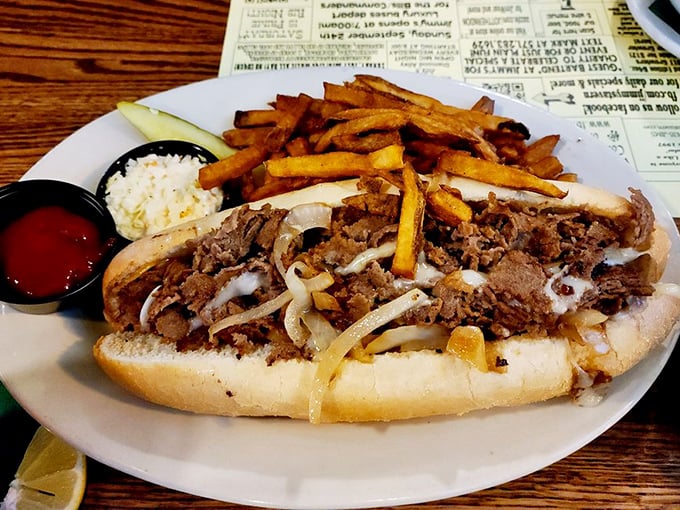 Behold the main attraction in all its glory! Thinly sliced beef, perfectly melted cheese, and those golden fries&mdash;a holy trinity of lunchtime perfection.