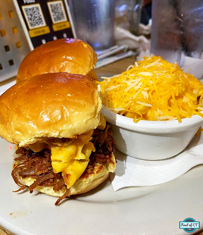 These sliders aren't playing games. Tender pulled pork meets melty cheese on pillowy buns, with a mountain of cheesy goodness standing guard alongside.
