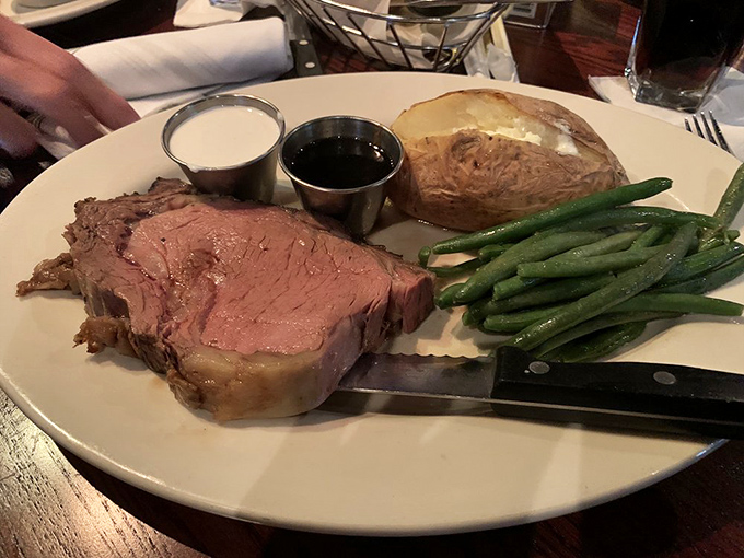 Prime rib so perfectly pink it makes you want to write poetry, accompanied by green beans that actually make eating vegetables worthwhile.